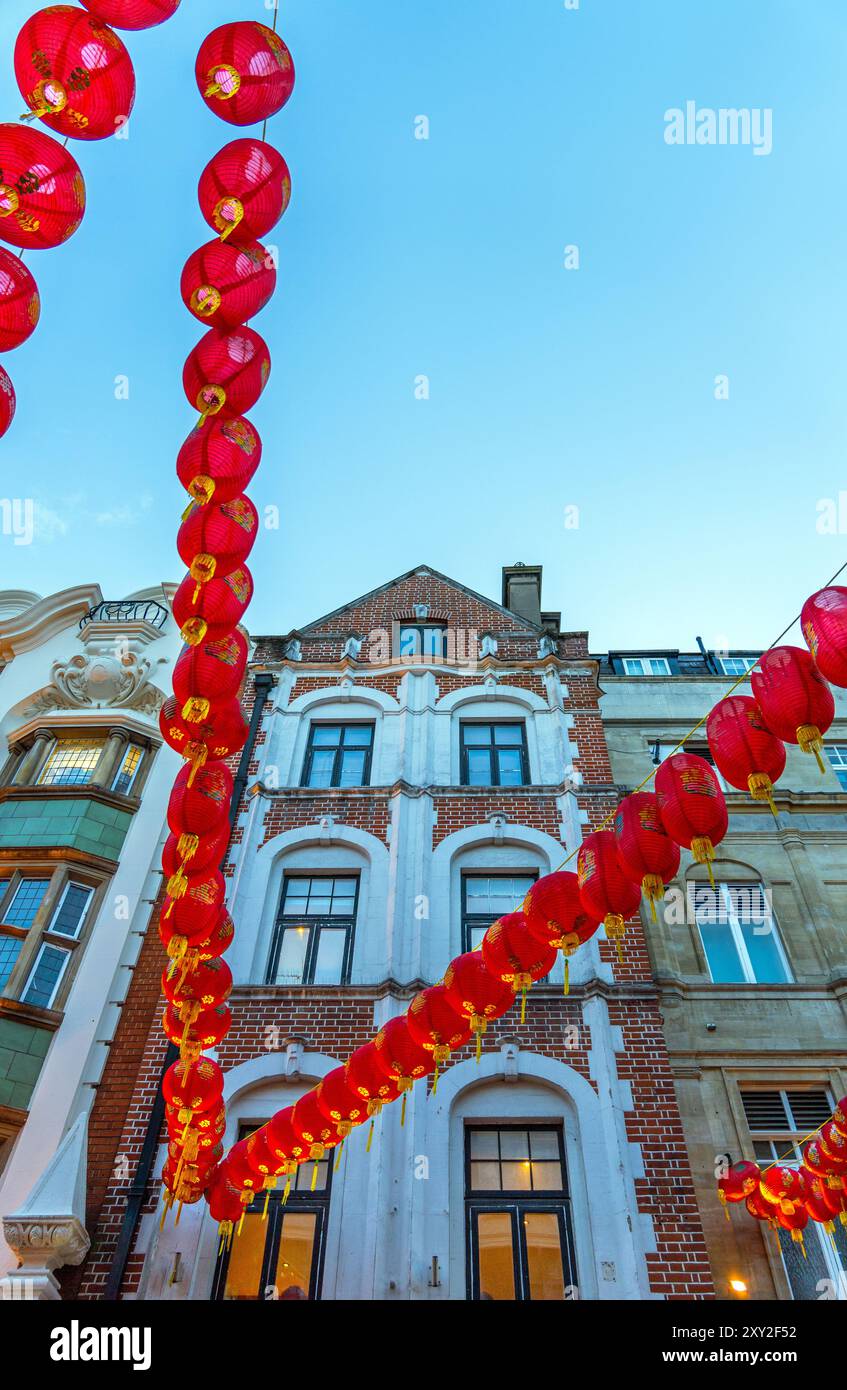 View from below at dusk of a London Chinatown street in Soho under a clear blue twilight sky and ...