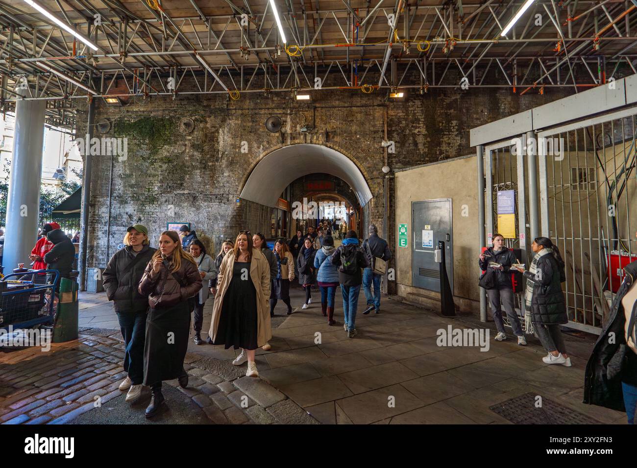 Entrance under the railway bridge to the modern Borough Market, with ...