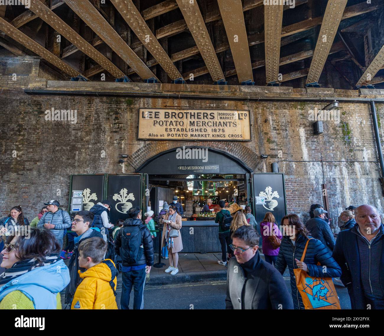 Entrance under the railway bridge to the modern Borough Market, with ...