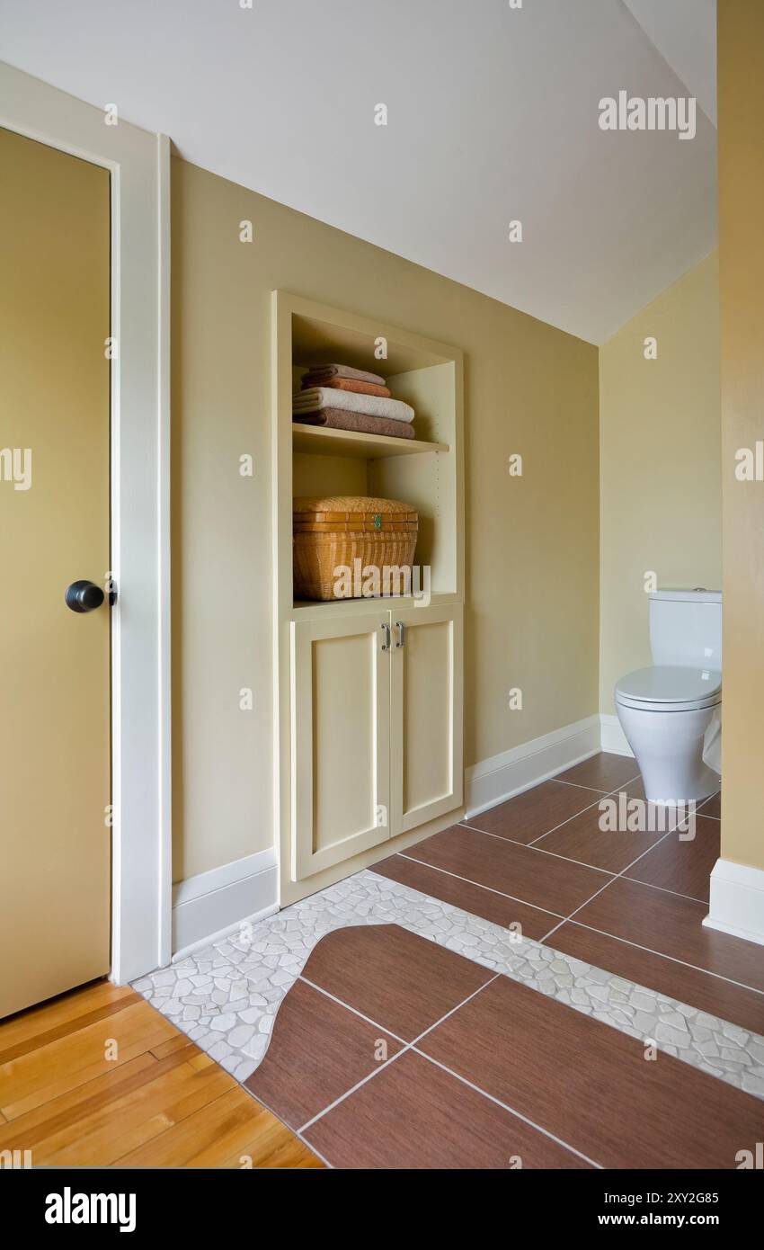 Part of bathroom with slanted ceiling showing toilet and built in ...