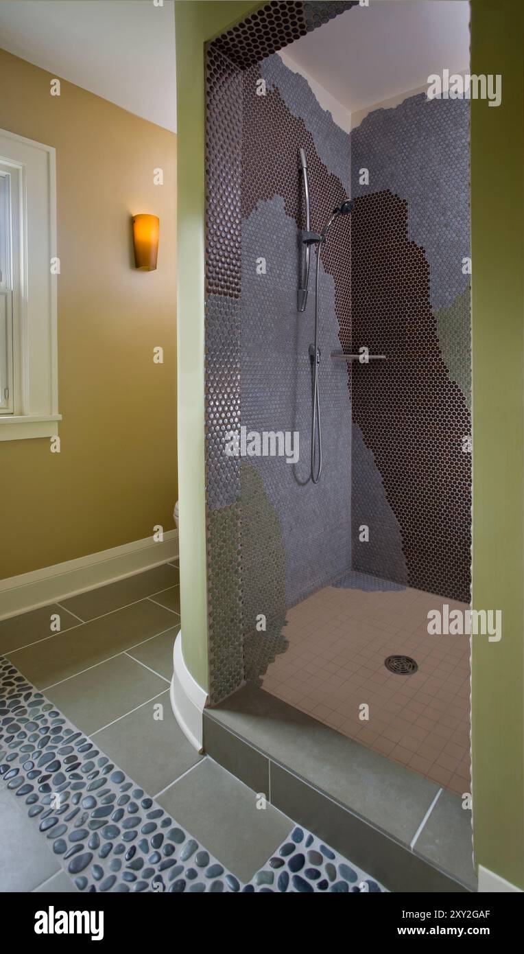 Walk-in shower with round mini tiles arranged in organic shapes by ...