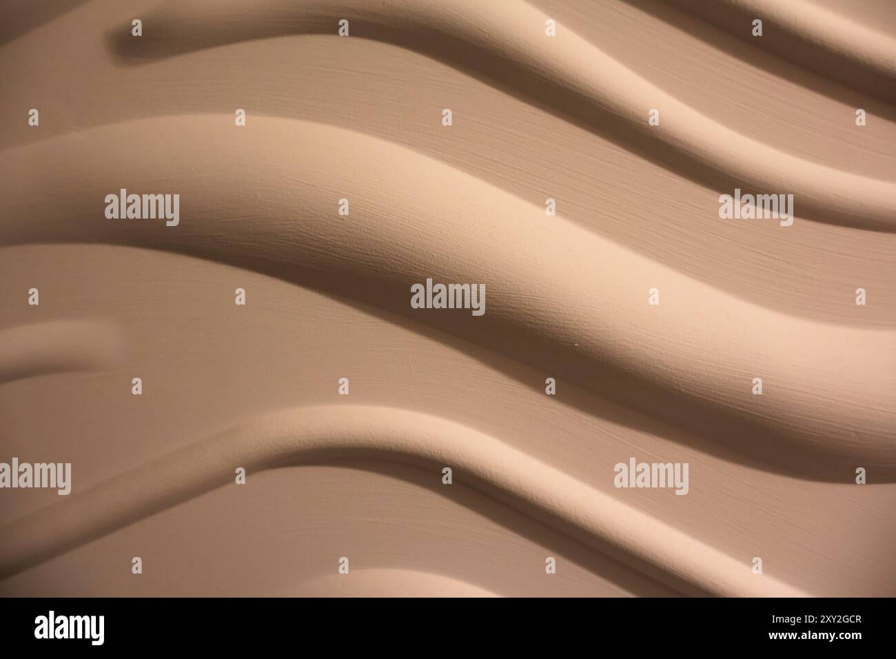 Close-up of a textured beige surface with flowing, wave-like patterns ...