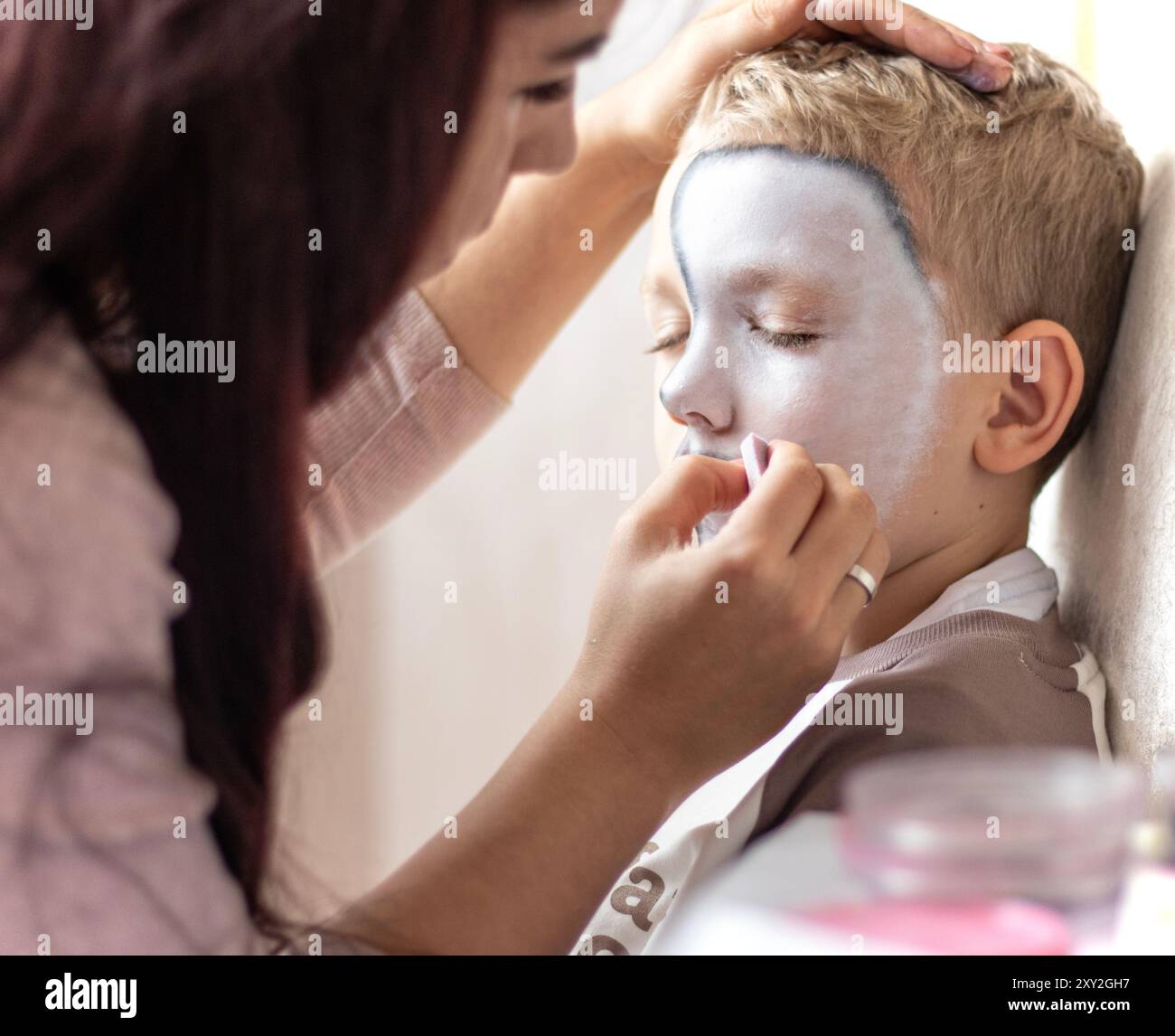 Master making aqua makeup on boys face. face painting kids. child Stock ...