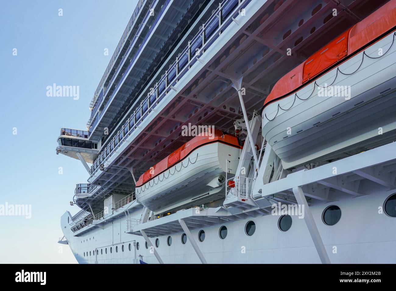 Fragment of a side view of a large modern luxury cruise ship with ...