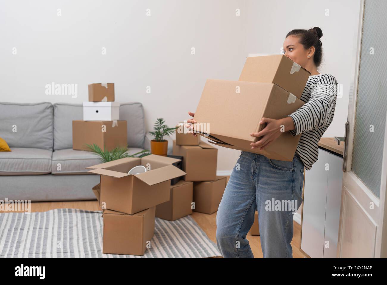 Woman holds heavy boxes with personal items in light premise Stock ...