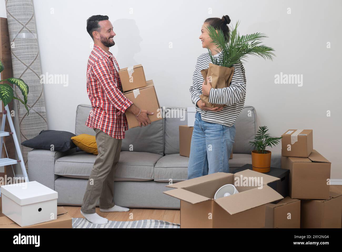 Couple packs things and household items in cardboard boxes Stock Photo ...
