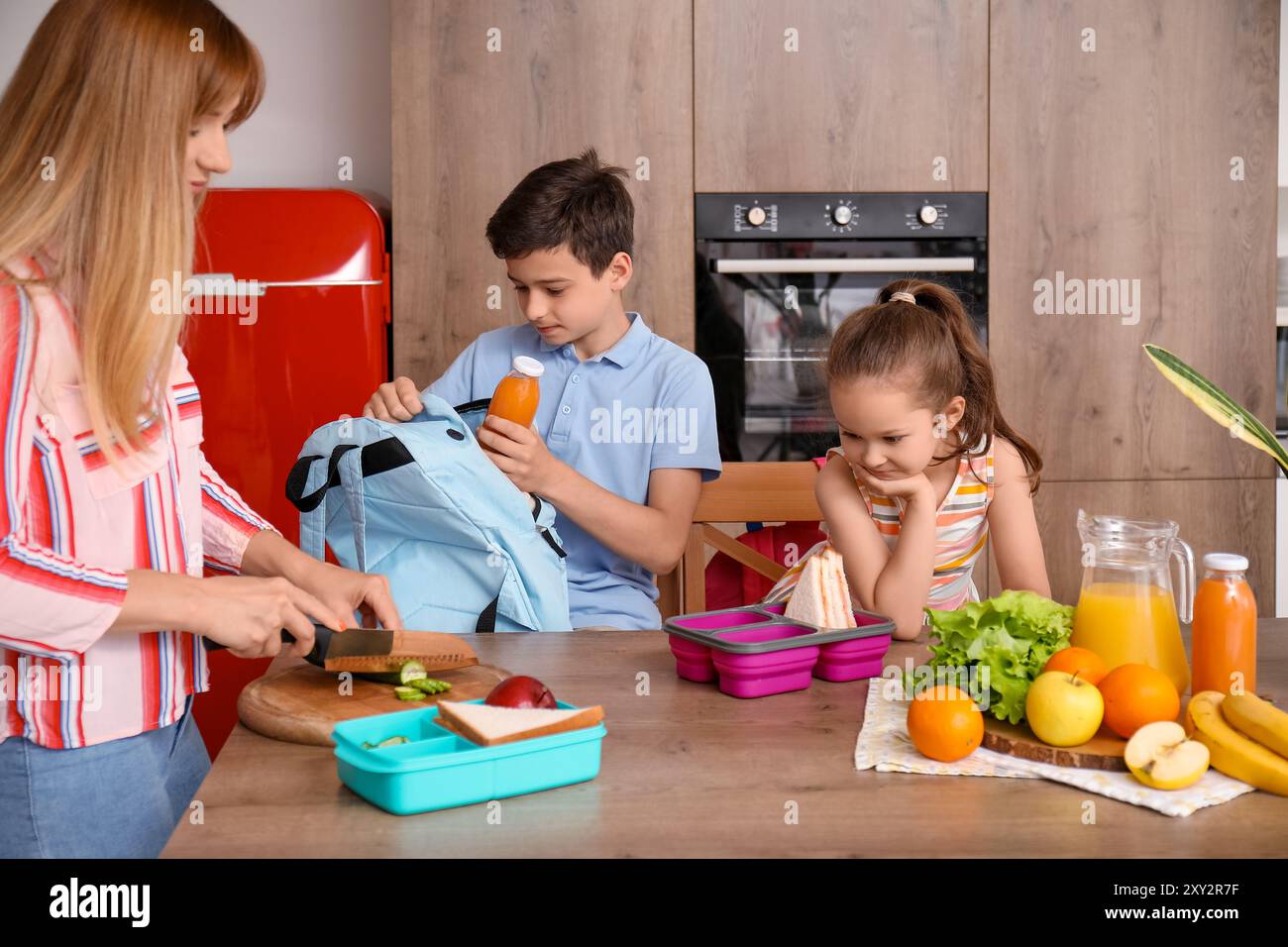 Mother preparing school lunch for her little children in kitchen Stock ...