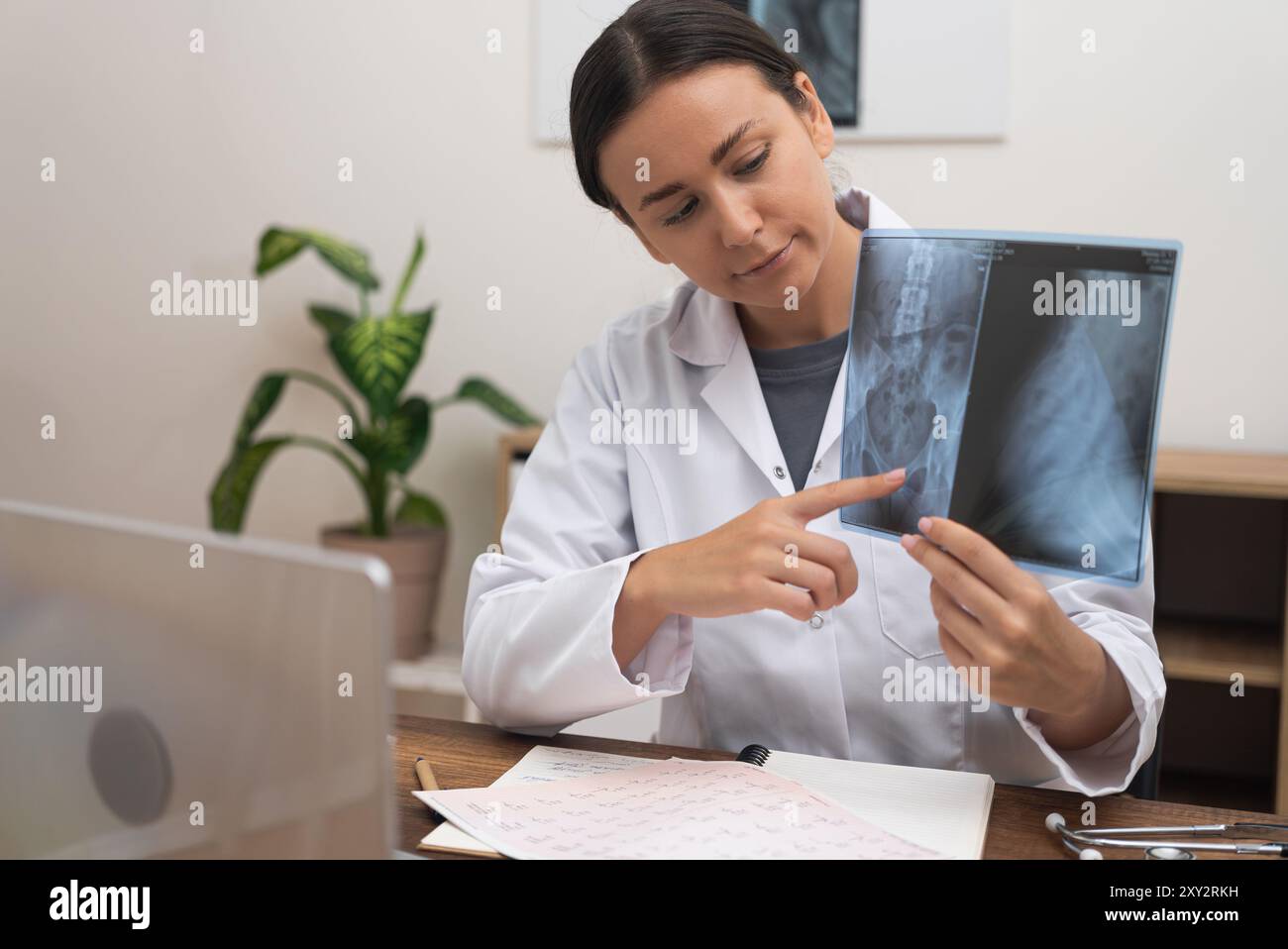 video call doctor utilizes telemedicine to display X-ray films to ...