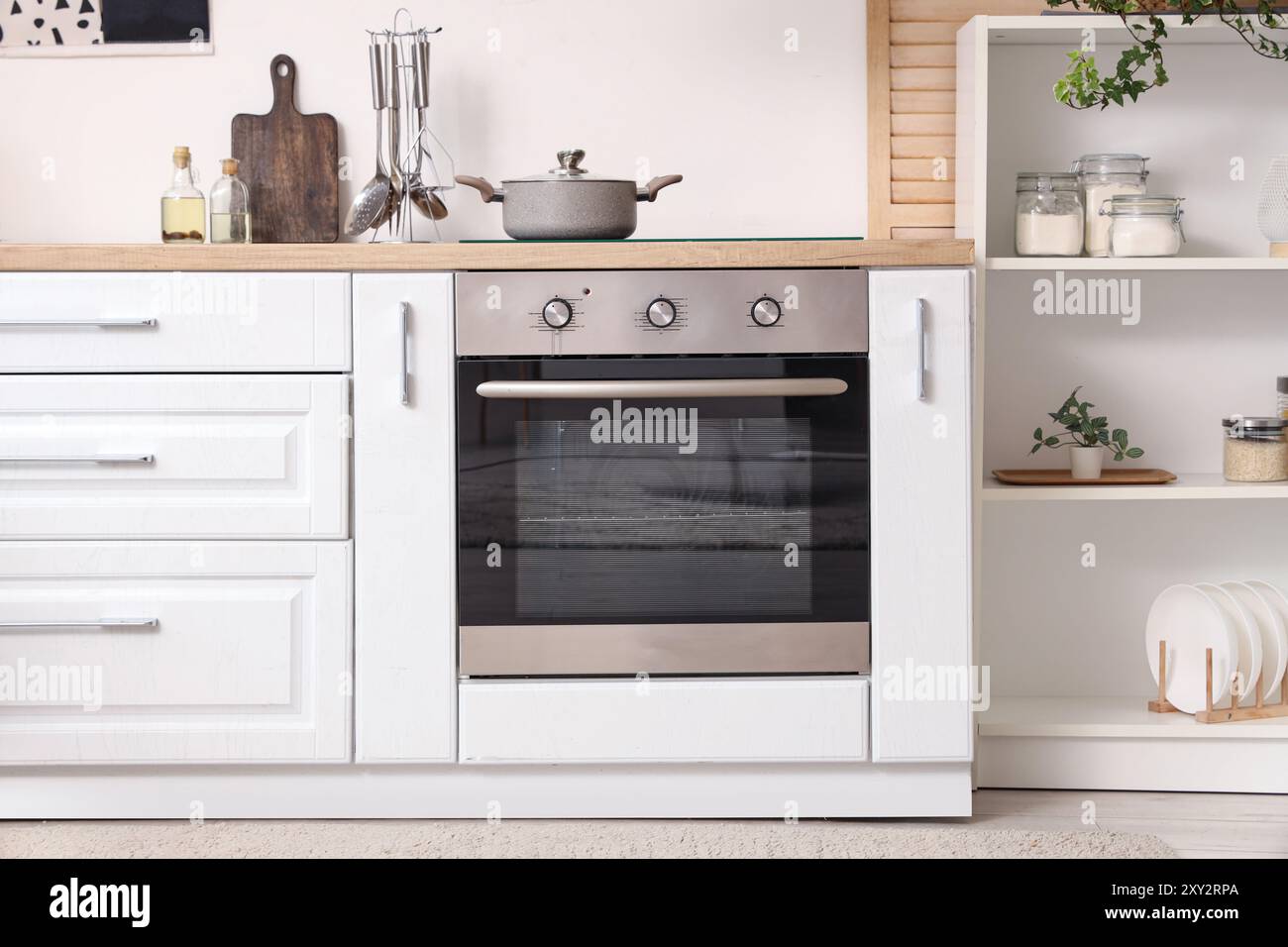 Interior of kitchen with white counters and oven Stock Photo - Alamy