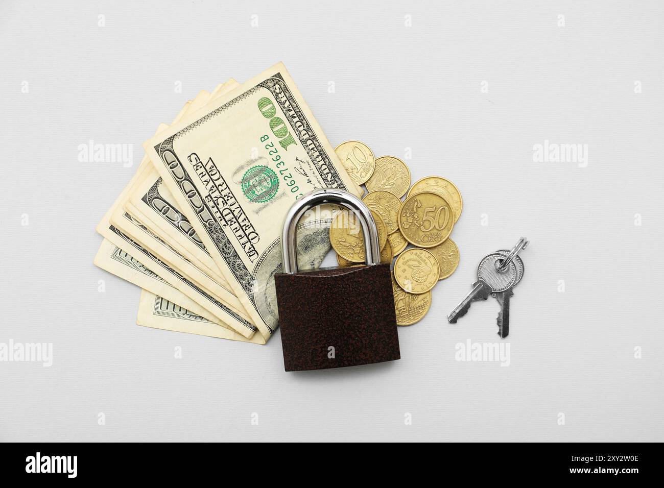 Money with padlock and keys on grey background Stock Photo - Alamy