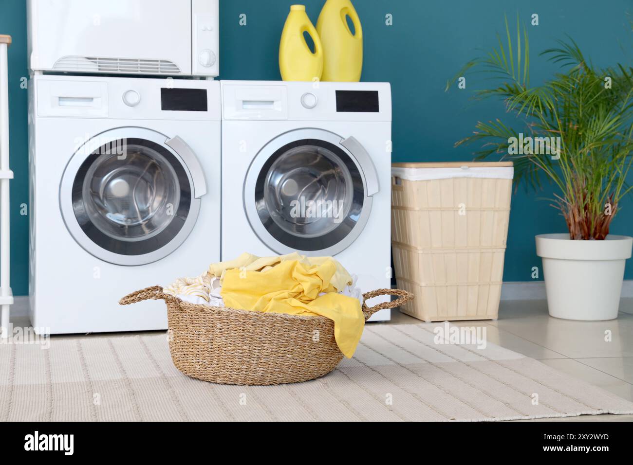 Interior of laundry room with washing machines, dryer and baskets Stock ...