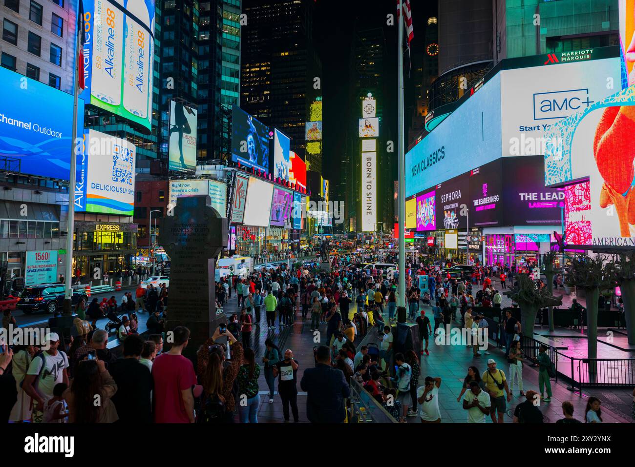 View of Times Square at night with large digital billboards, bright ...