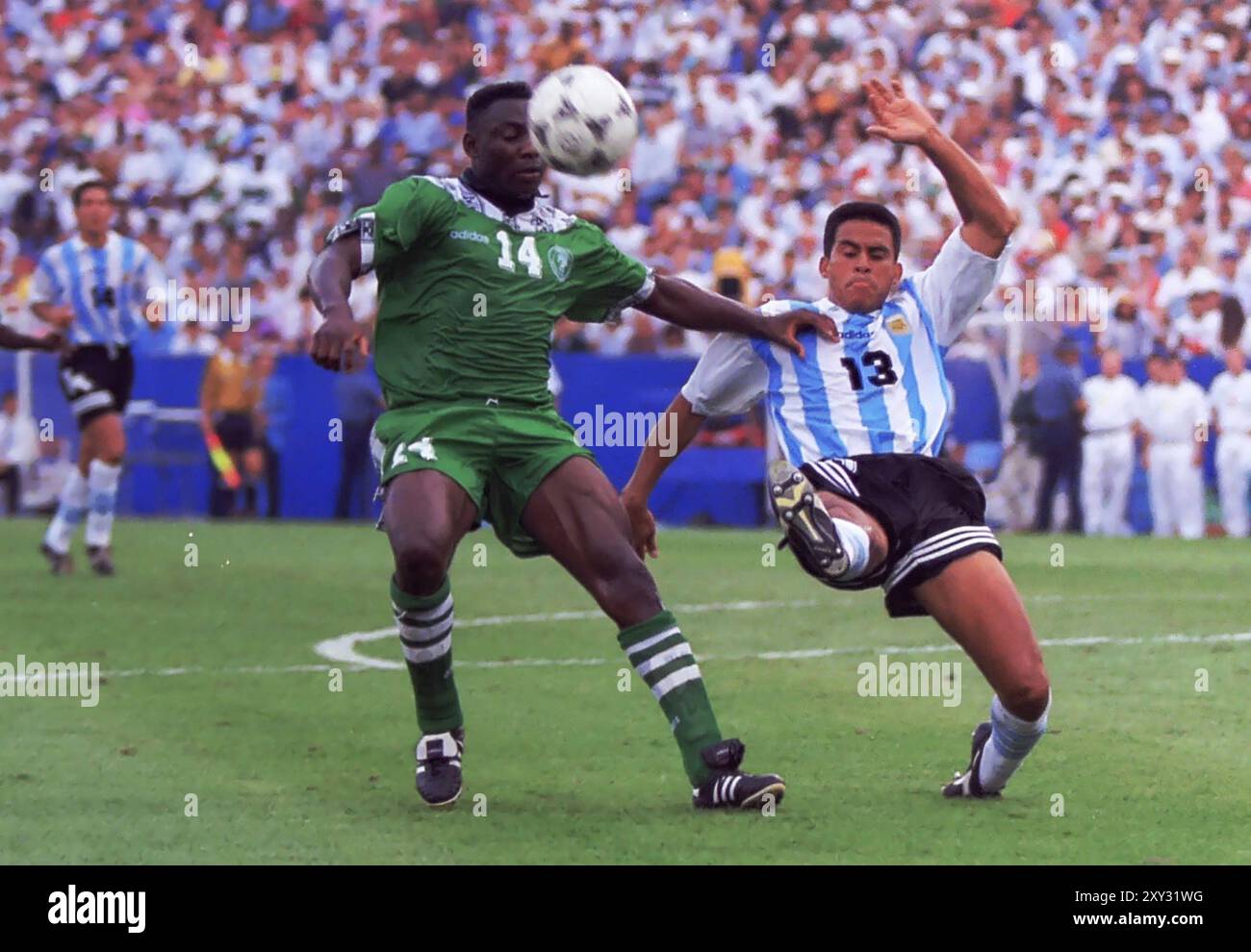 Fernando Caceras (13) of Argentina clashes with Daniel Amokachi (14) of ...