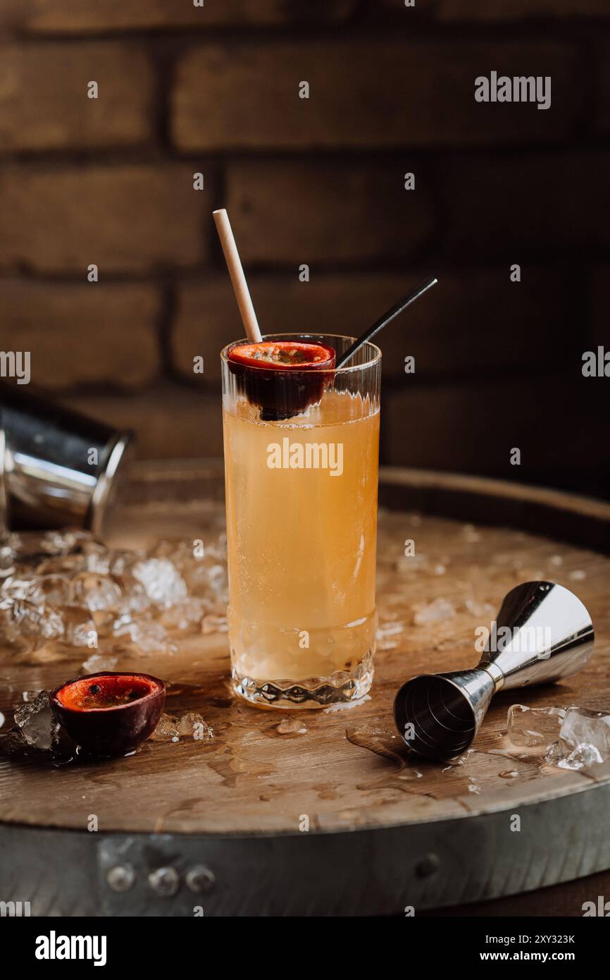 Refreshing passion fruit cocktail in highball glass, for summer vibes and tropical-themed events ...