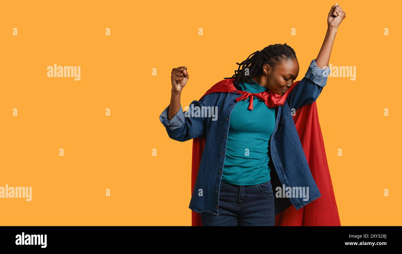 Happy superhero flexing muscles to prove force, listening music ...