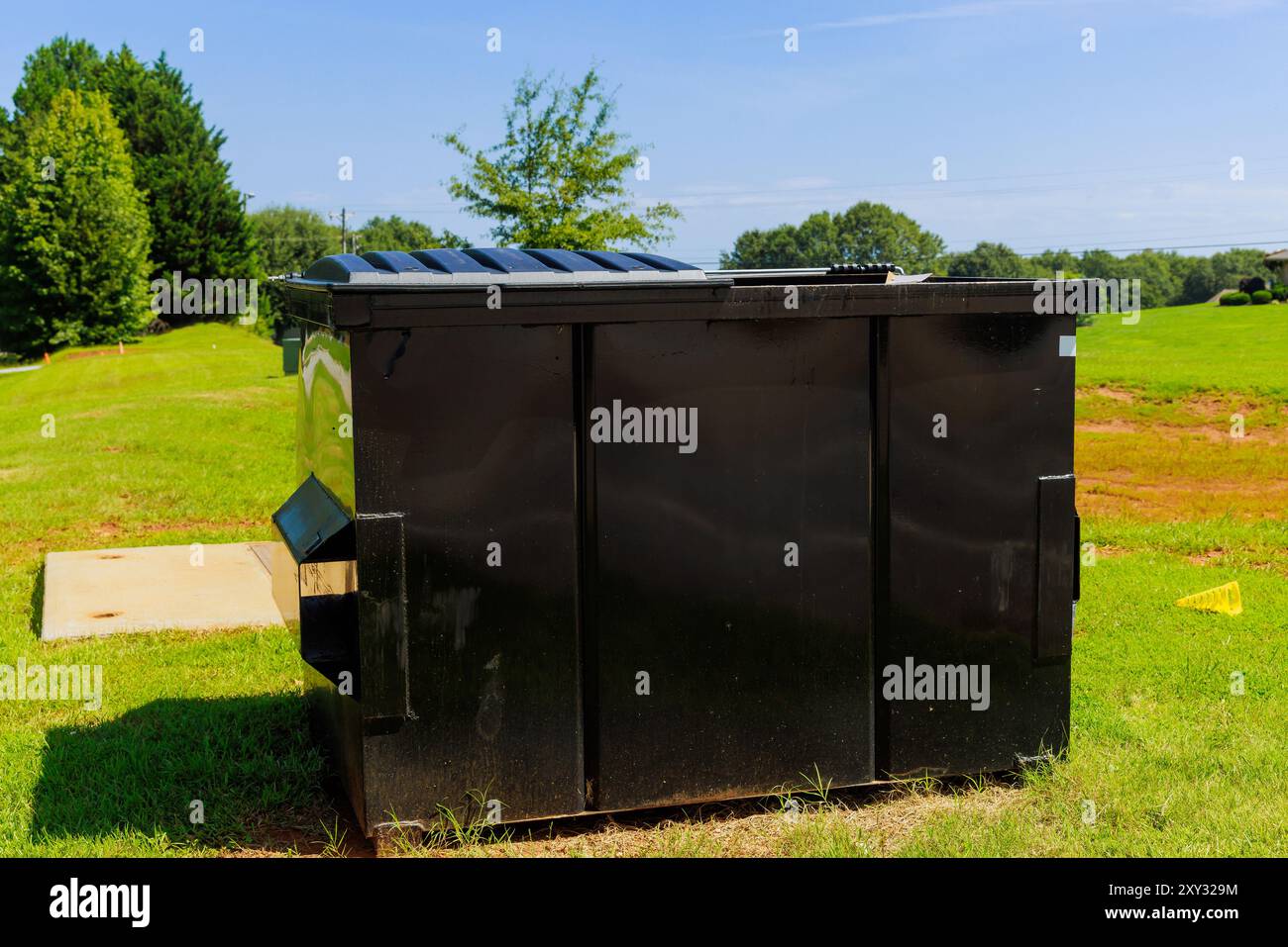 At construction site, metal containers are used to collect waste during ...