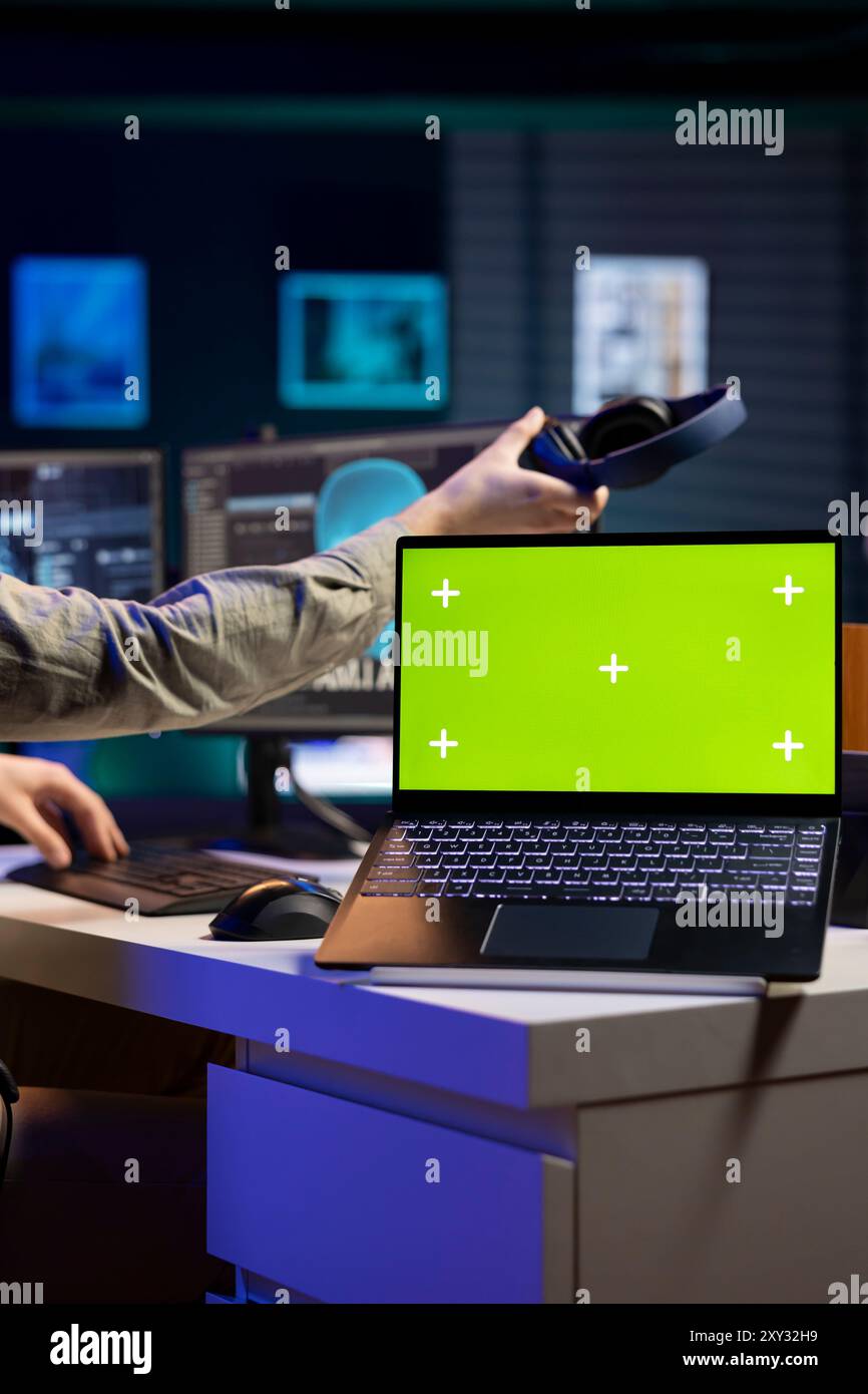 Focus on green screen laptop used by developer updating artificial intelligence machine learning ...