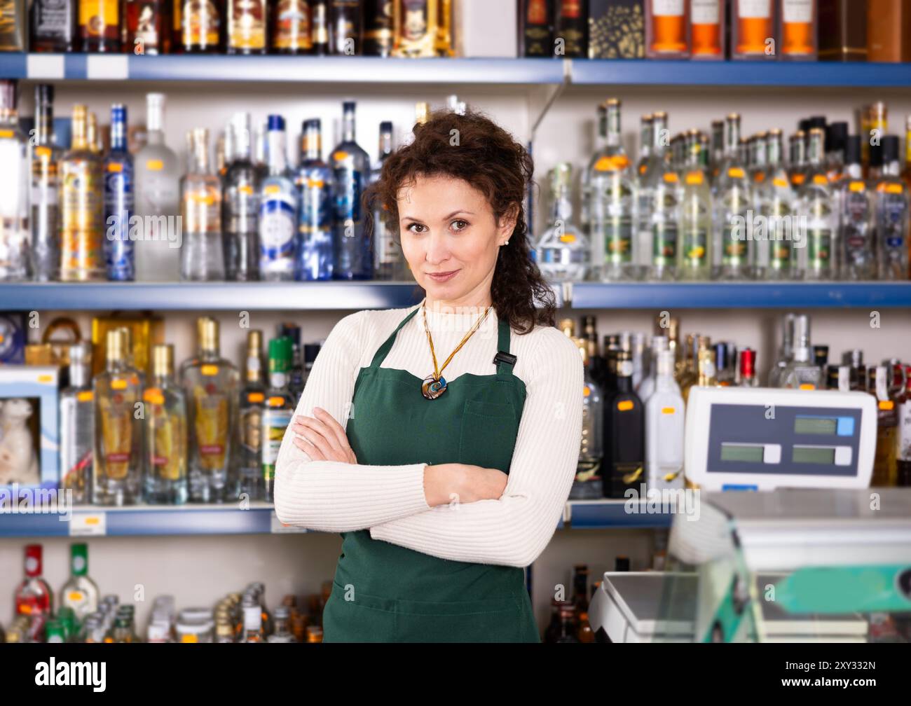 Adult saleswoman posing at store counter Stock Photo - Alamy