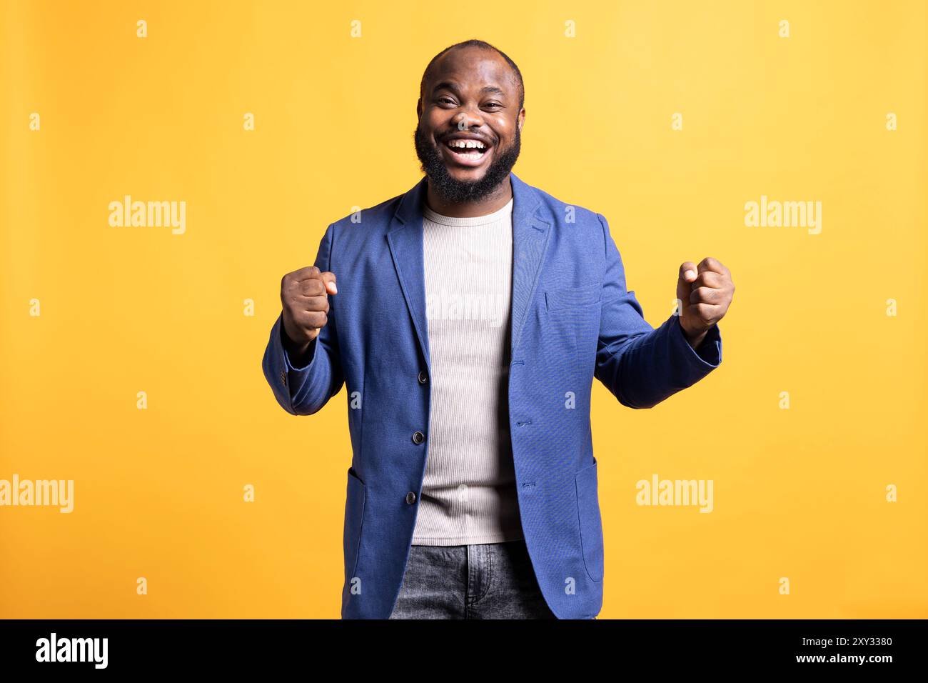 Portrait of joyful cheerful african american man celebrating, showing ...