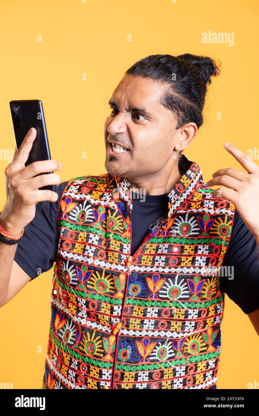 Upset indian man having rude dispute with friends during telephone call ...