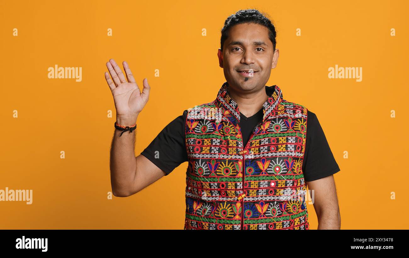 Portrait of jolly man smiling and waving hand, saluting, gesturing ...