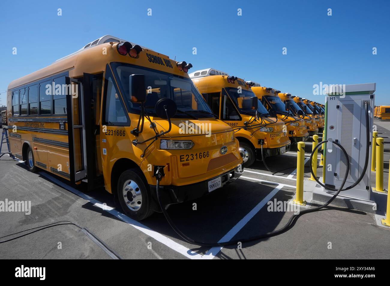 Zum electric buses are plugged into charging stations before a news ...