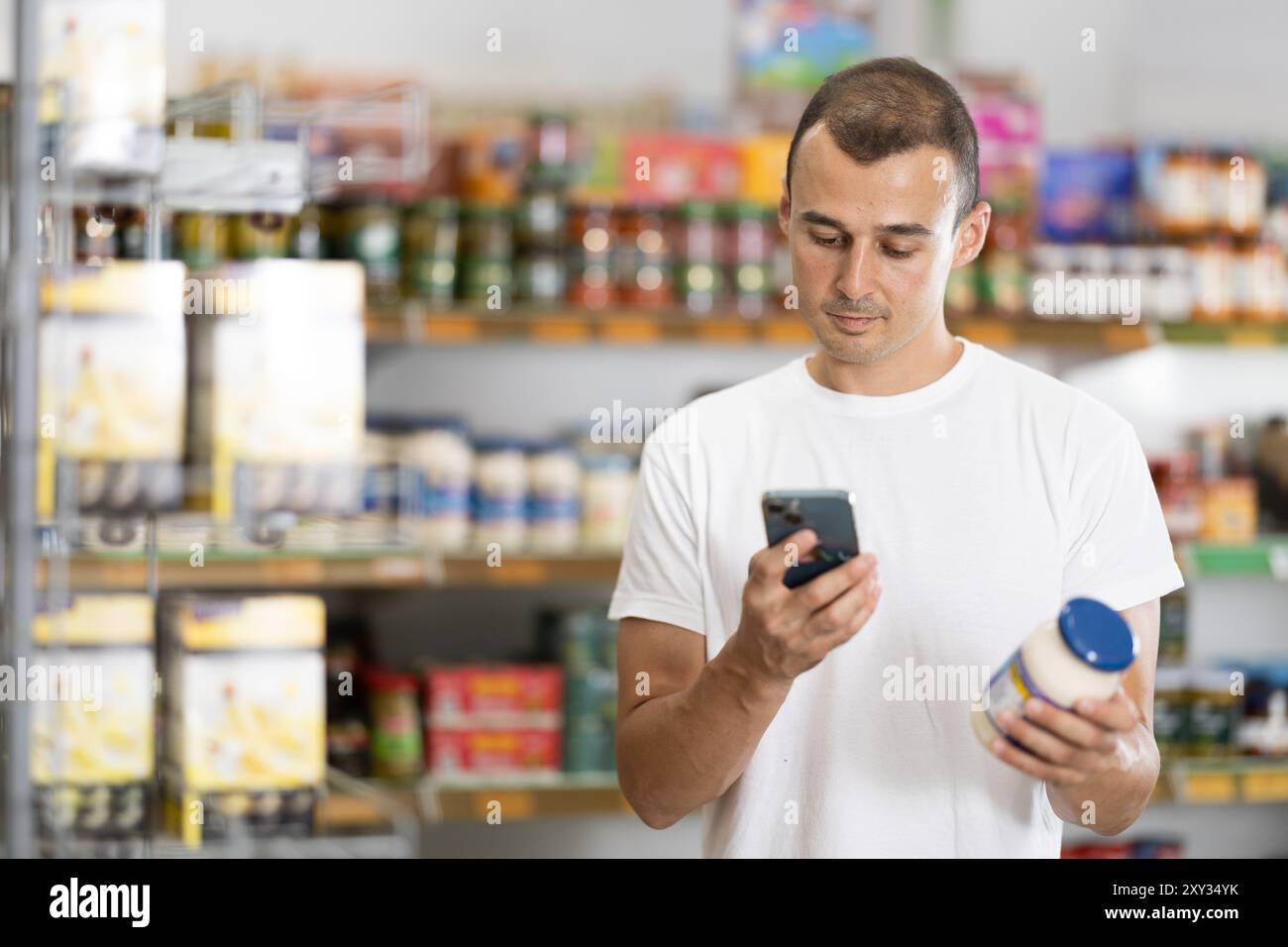 Male shopper scanning barcode or qr code with smartphone on mayonnaise label Stock Photo - Alamy