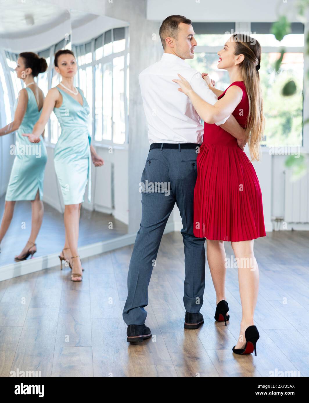 Couple in stage costumes learns waltz dancing during individual lesson ...
