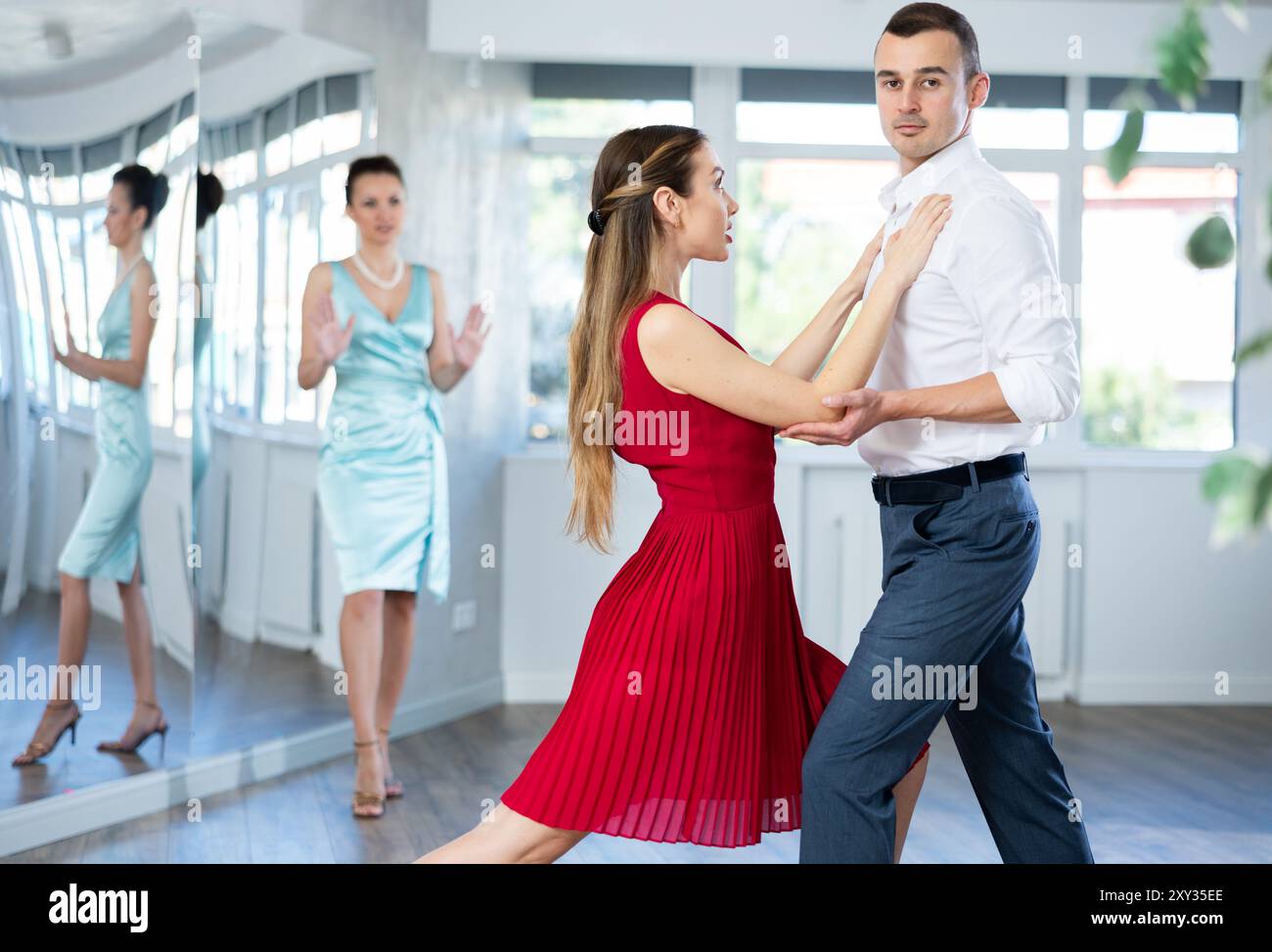Graceful duet dancing passionate tango during dance class Stock Photo ...
