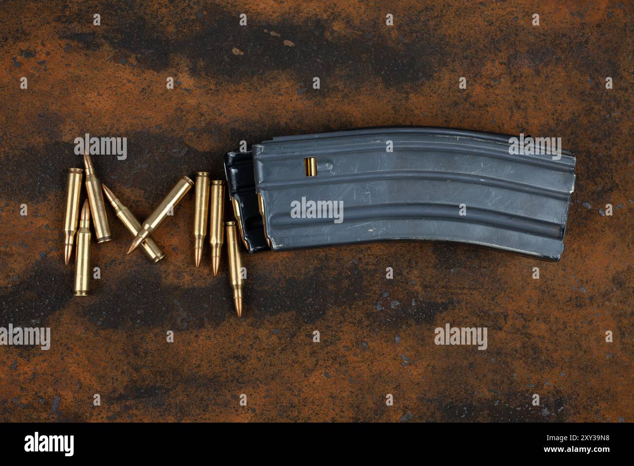 Ammunition with magazine on rusty metal background Stock Photo - Alamy