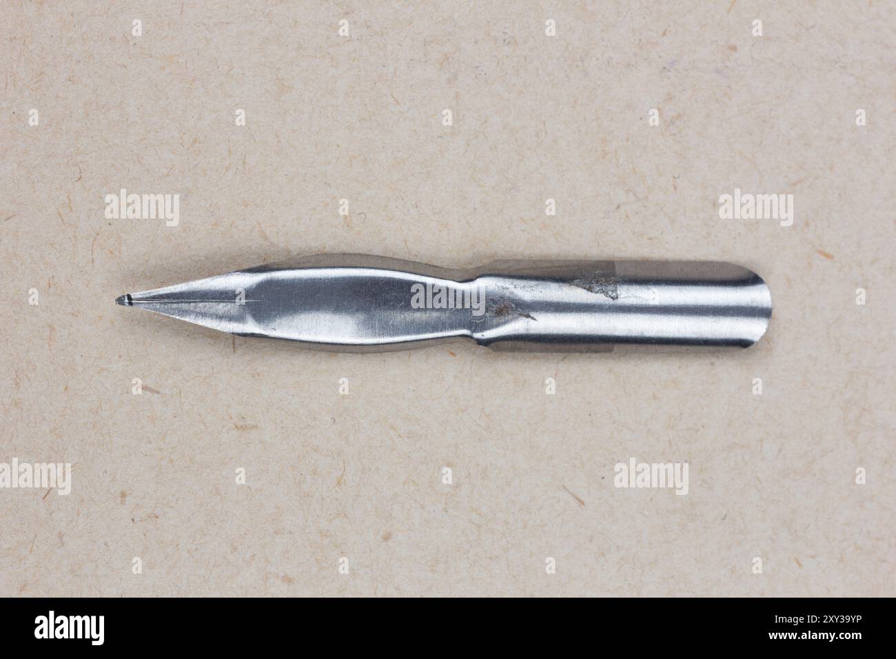 Metal nibs on an antique textured paper background Stock Photo - Alamy