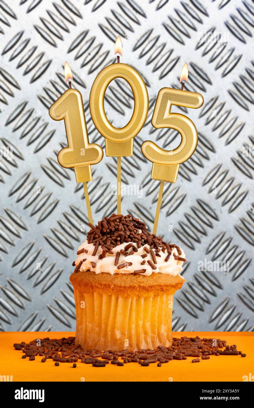 Chocolate cupcake with candle number 105 - Birthday on industrial ...