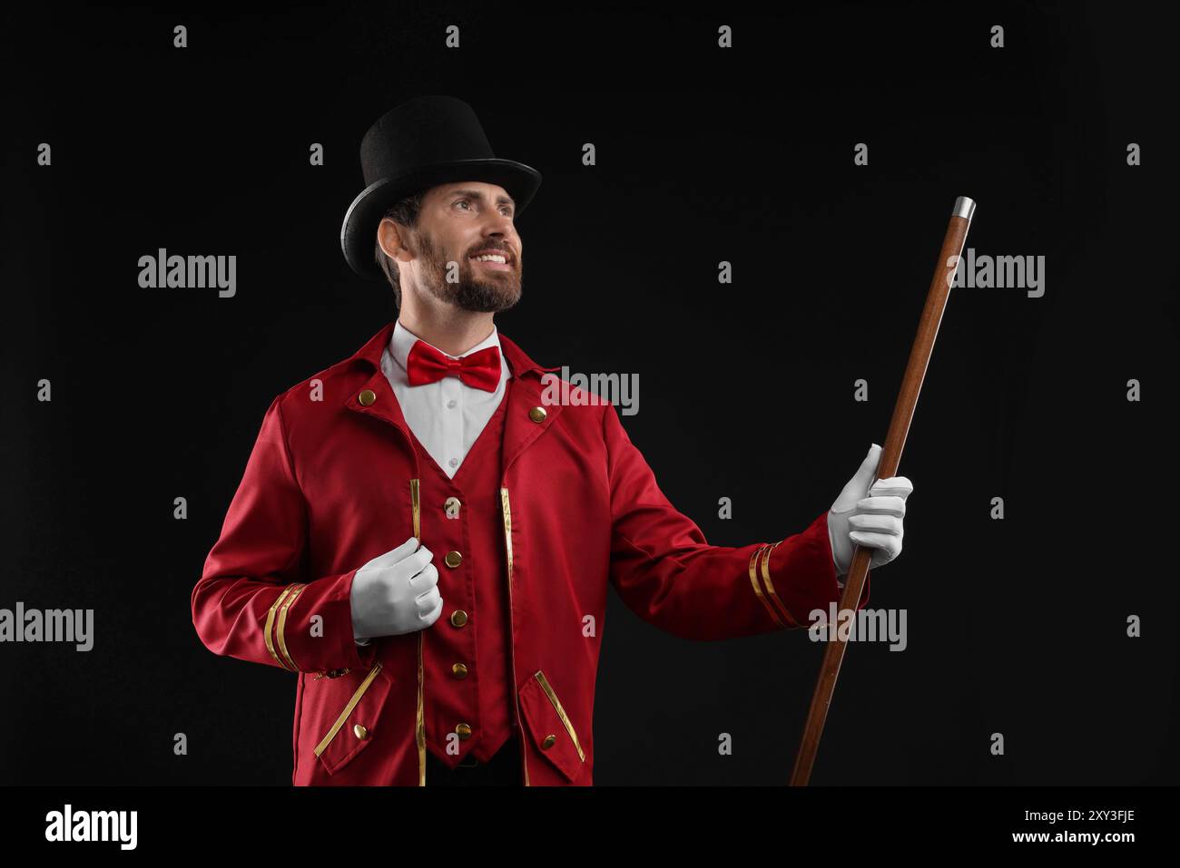 Portrait of showman in red costume and hat on black background Stock ...