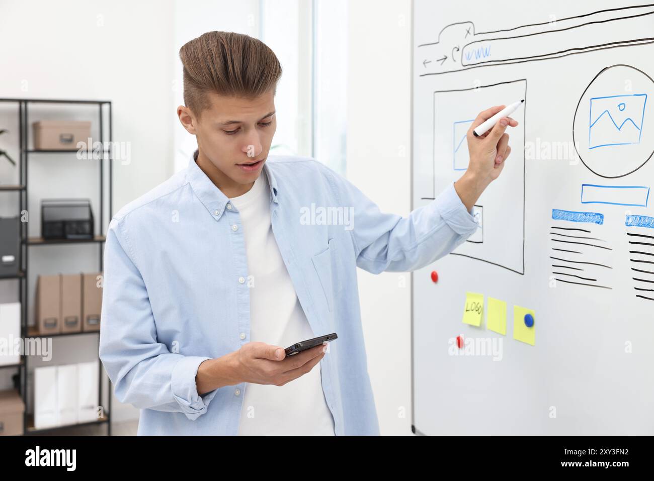 Developing UI design. Man drawing website wireframe on whiteboard ...