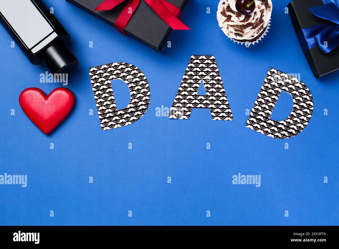 Happy Father's Day. Word Dad made of paper, decorative heart, perfume ...