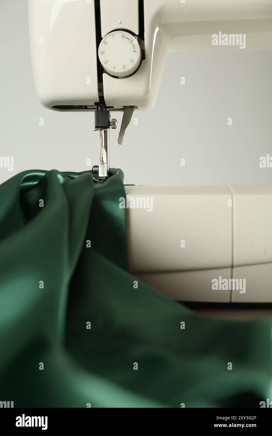 Sewing machine with green fabric on white background, closeup Stock ...