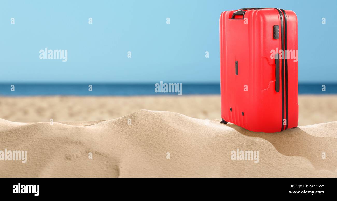 One red suitcase on sandy beach near sea. Banner design with space for ...