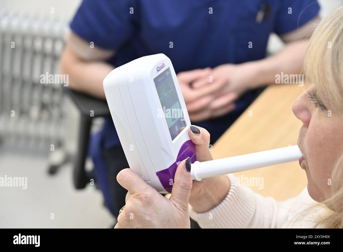 Patient undergoing a fractional exhaled nitric oxide (FeNO) test ...