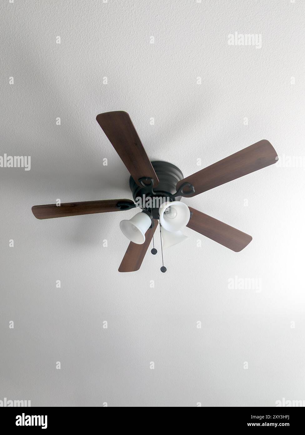 Five blade electric ceiling fan mounted on white ceiling Stock Photo ...