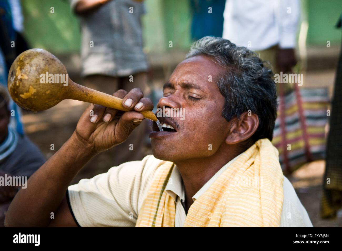 A Bonda tribe man drinking toddy from a dried gourd. Malkangiri, Odisha ...