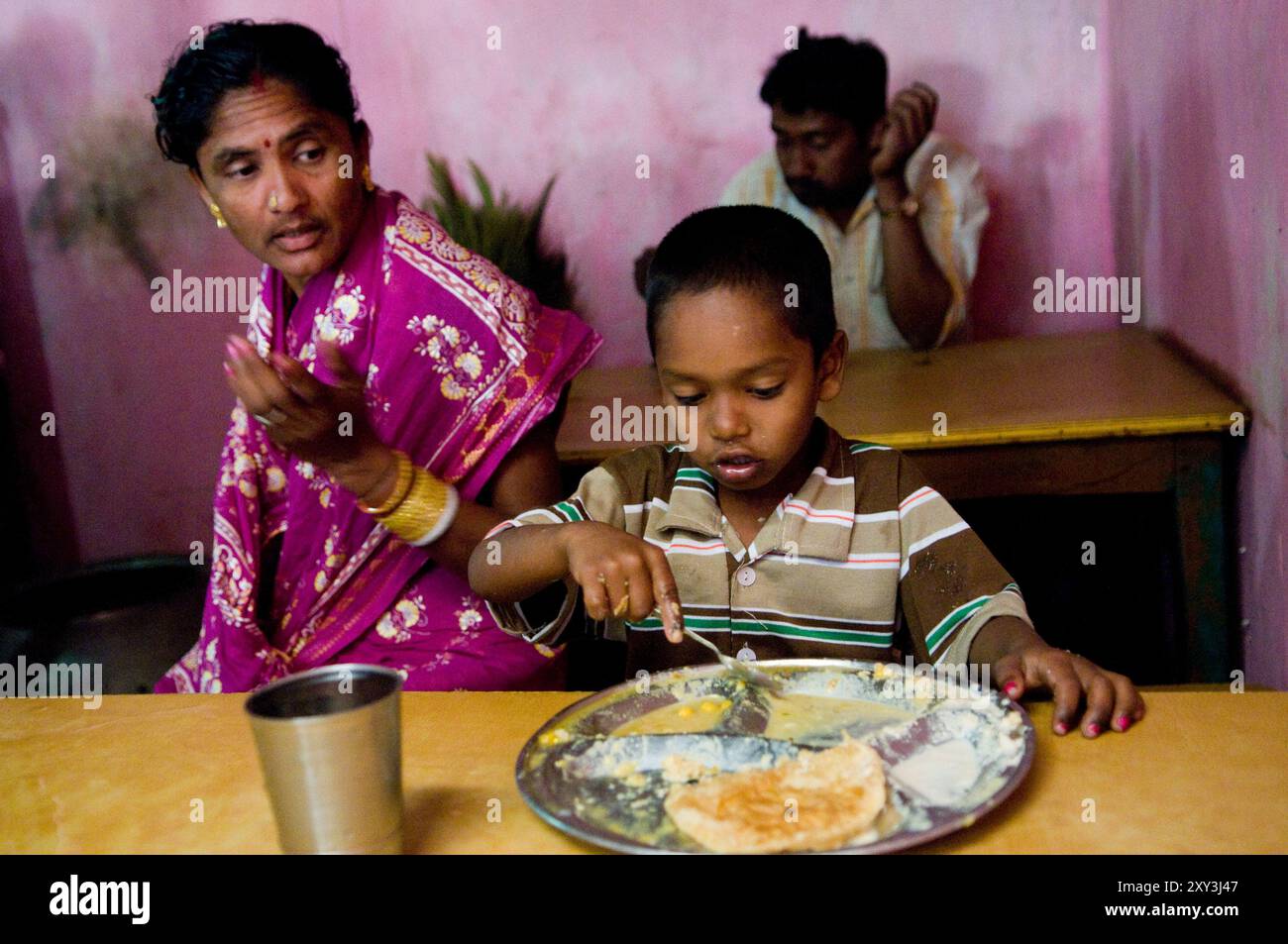 An Odia boy eating dosa in a small hole in the wall restaurant in ...