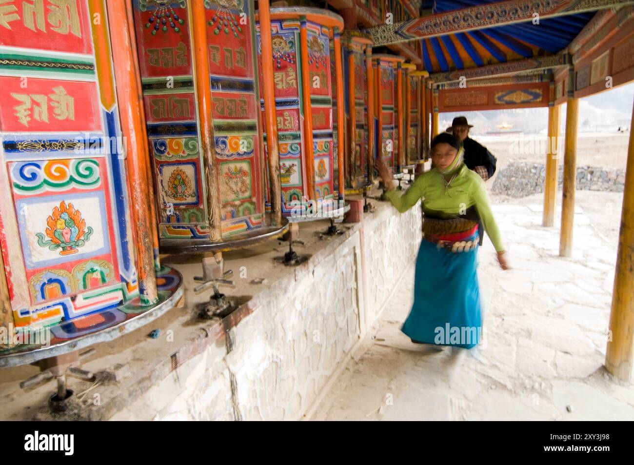 Tibetan pilgrims spinning prayer wheels around the Labrang monastery in ...