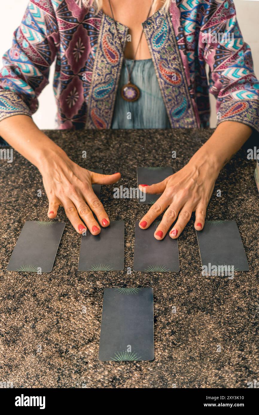 Insightful tarot reader shuffling the cards, creating a moment of ...