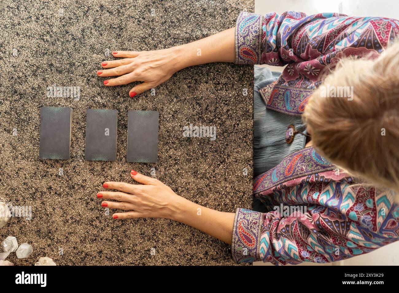 Top view of a tarot reader and three cards turned face down Stock Photo ...