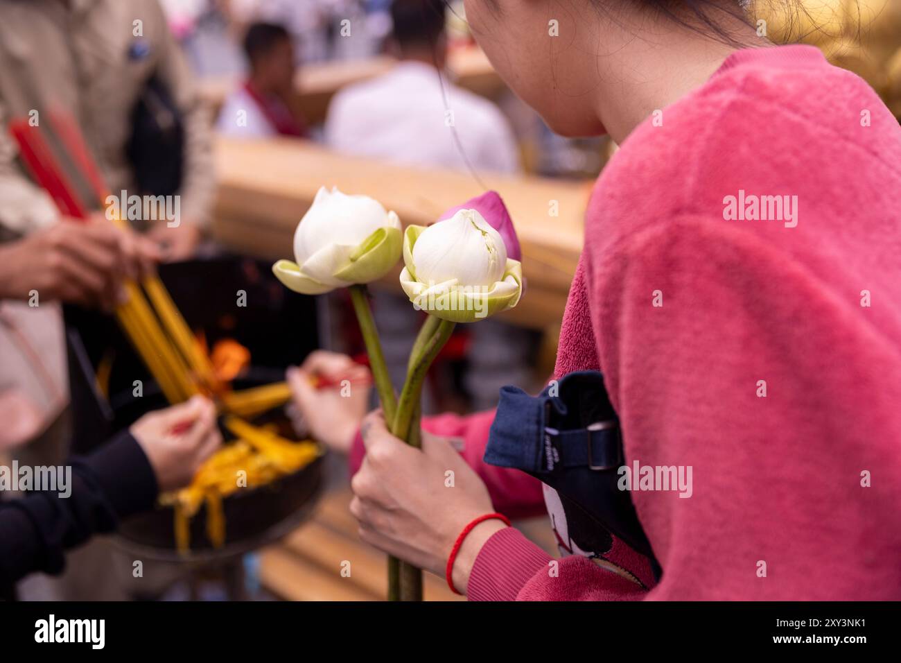 Visitors holding lotus flowers at Lok Ta Dombong Dek, Lok Ta Krohom Ko ...