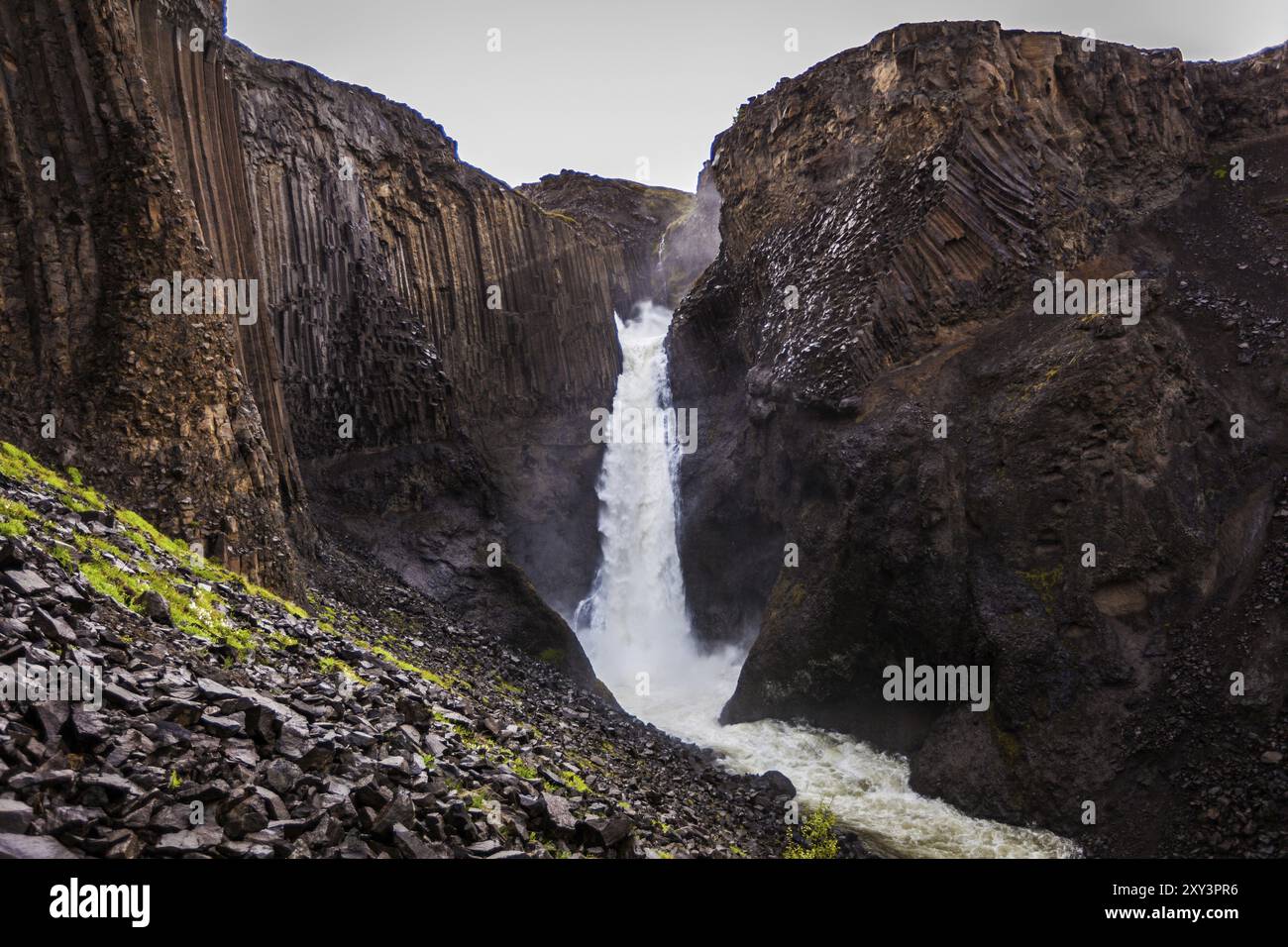 Litlanesfoss waterfall gushing through volcanic rock on Iceland Stock ...