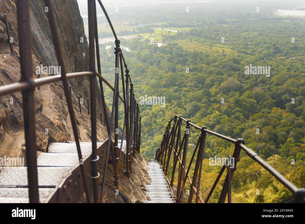 Steep and precarious metal steps lead down from Sigiriya rock to the ...