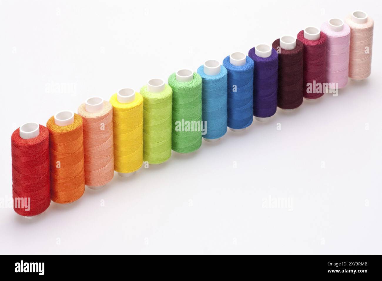 Multi-colored rainbow threads for sewing Stock Photo - Alamy