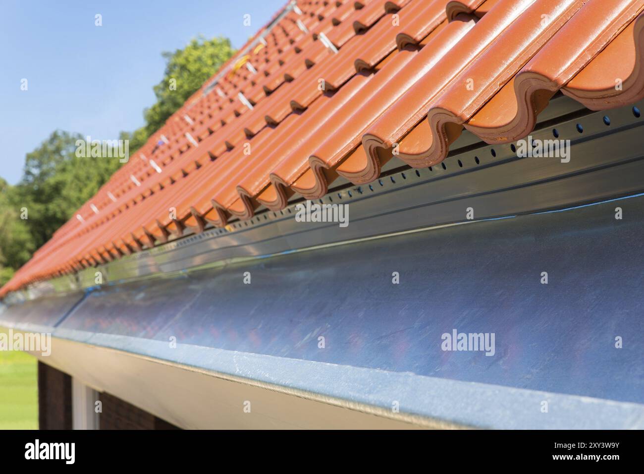 Close up gutter with roof tiles at new house Stock Photo - Alamy