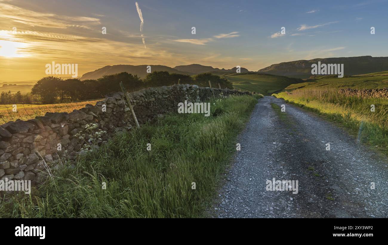 Sunset over a rural road in the Yorkshire Dales near Settle, North ...